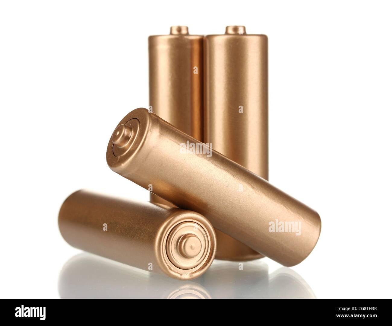 four golden batteries isolated on white Stock Photo - Alamy