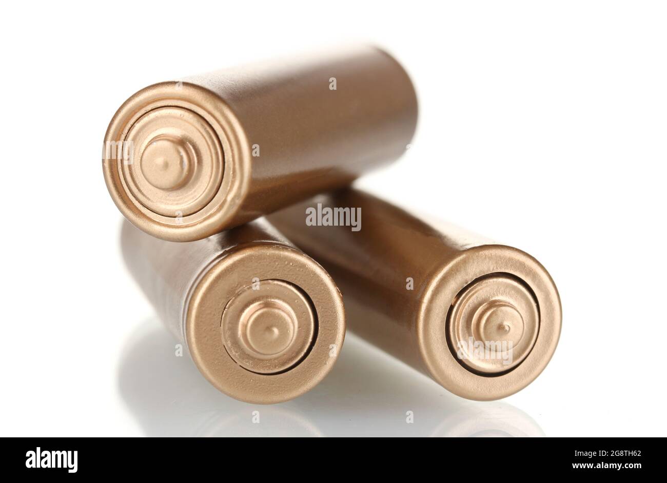 three golden batteries isolated on white Stock Photo - Alamy