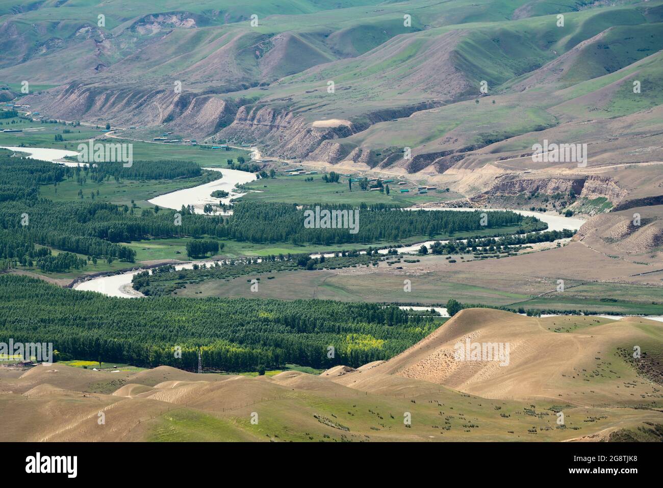 Meandering river and mountains in a sunny day. Shot in Xinjiang, China ...