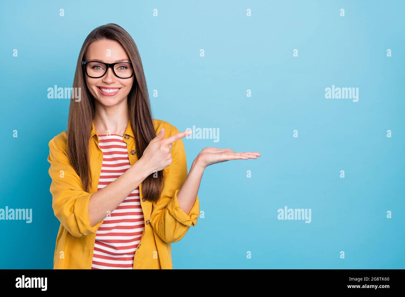Photo of young woman happy positive smile point finger product promo ...