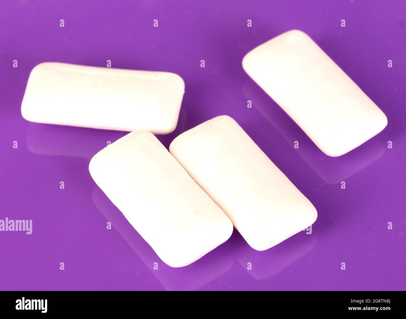 Chewing gums on purple background Stock Photo - Alamy
