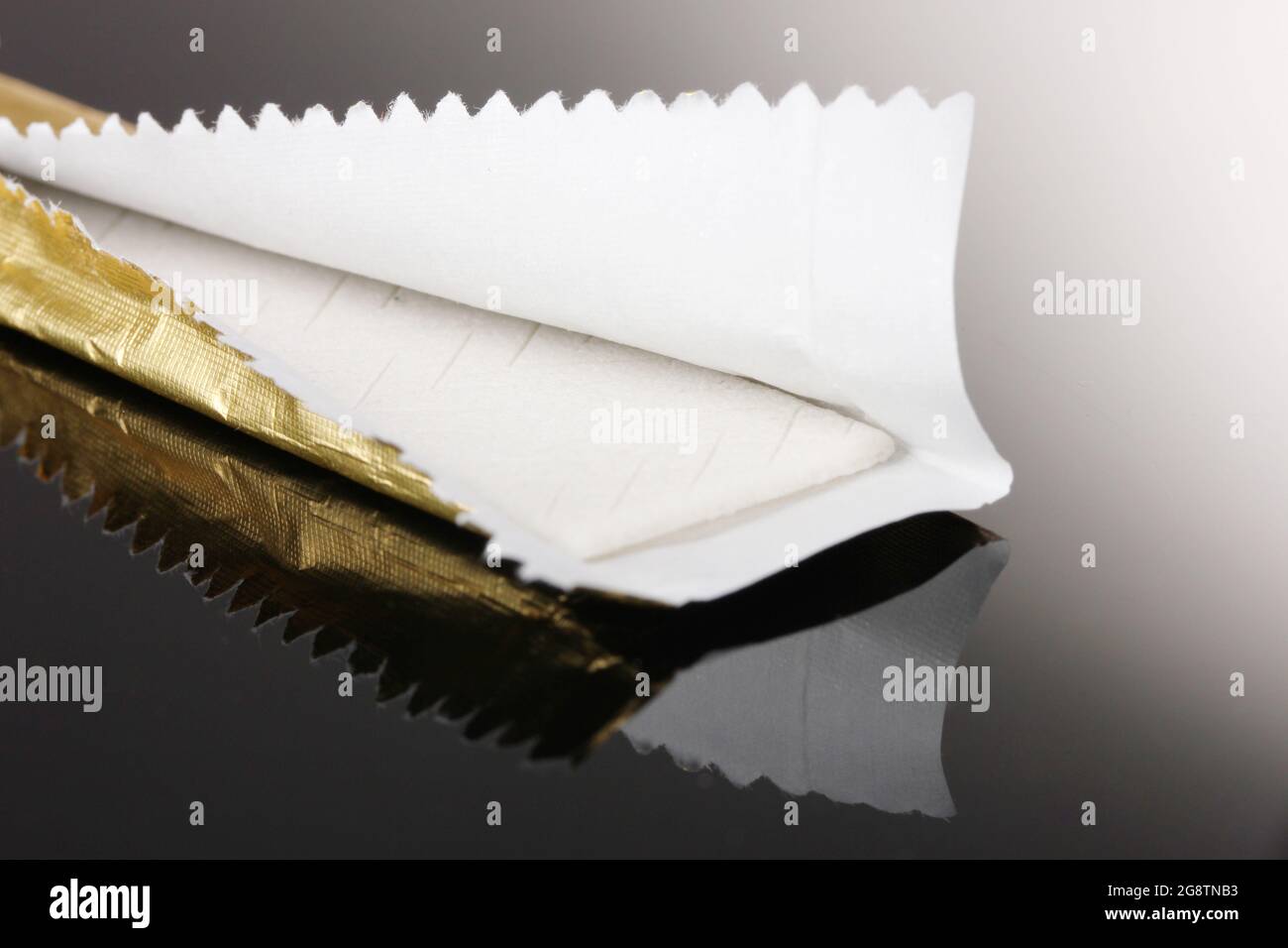 Chewing gum on the wrapping foil on gray background Stock Photo - Alamy