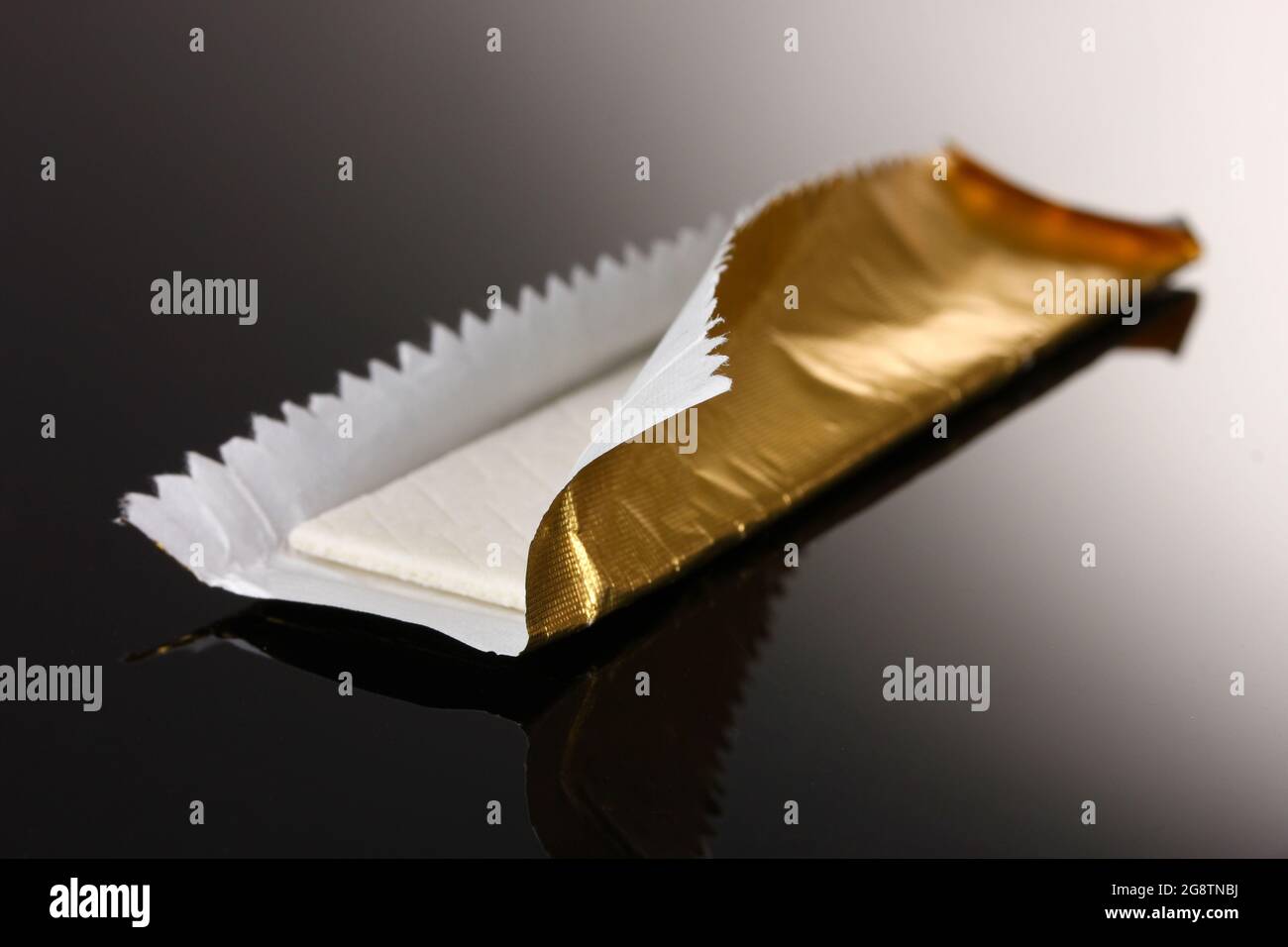 Chewing gum on the wrapping foil on gray background Stock Photo - Alamy