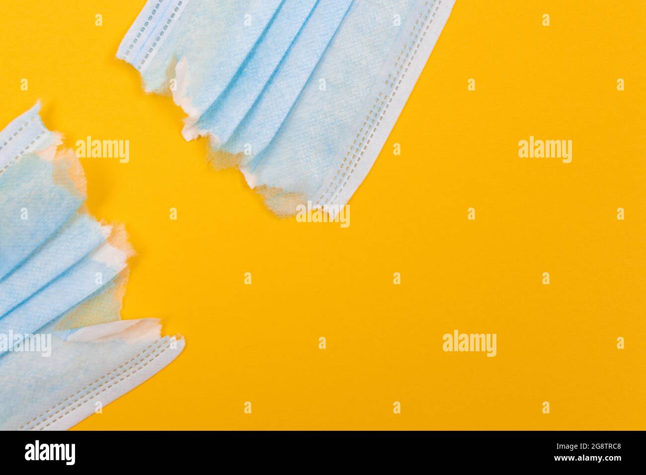 Anti Mask Concept - Torn Medical Face Mask Lying on Yellow Background ...