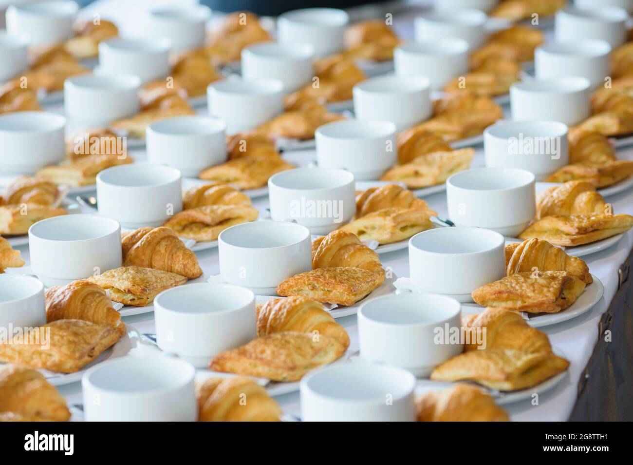 line of croissant waiting for coffee break Stock Photo - Alamy