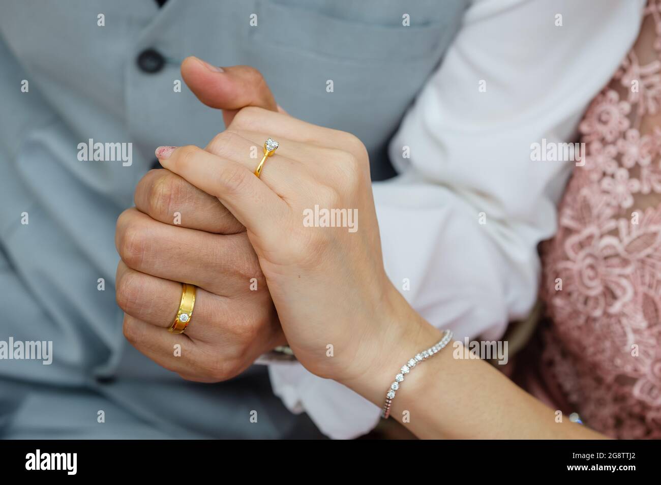 wedding rings together in hands Stock Photo - Alamy