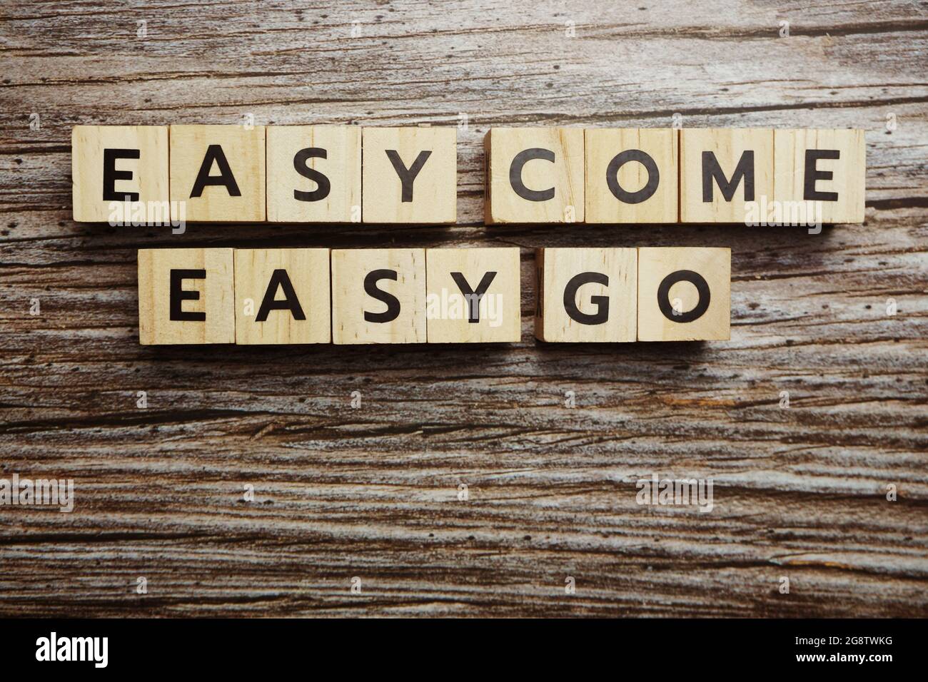 Easy Come Easy Go alphabet letters on wooden background Stock Photo - Alamy