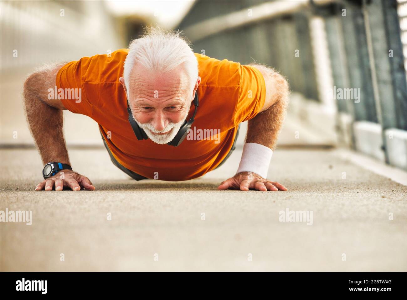 An elderly man doing push-up exercise for better quality of life Stock ...