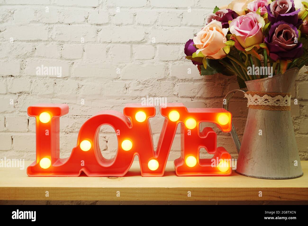 Pink Love LED Decorative on white brick wall background Stock Photo - Alamy