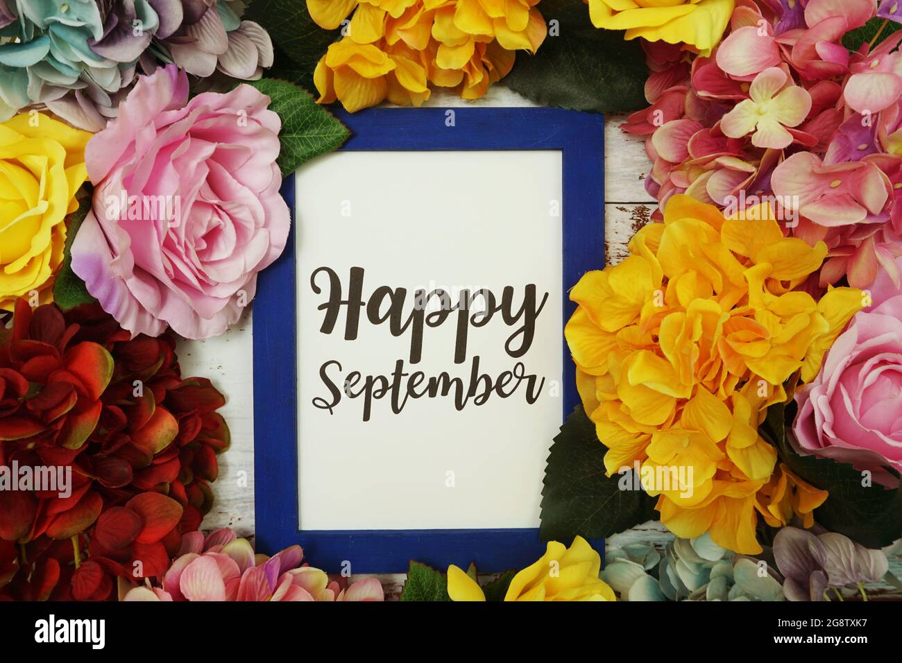 Happy September Card with colorful flowers border frame on wooden ...
