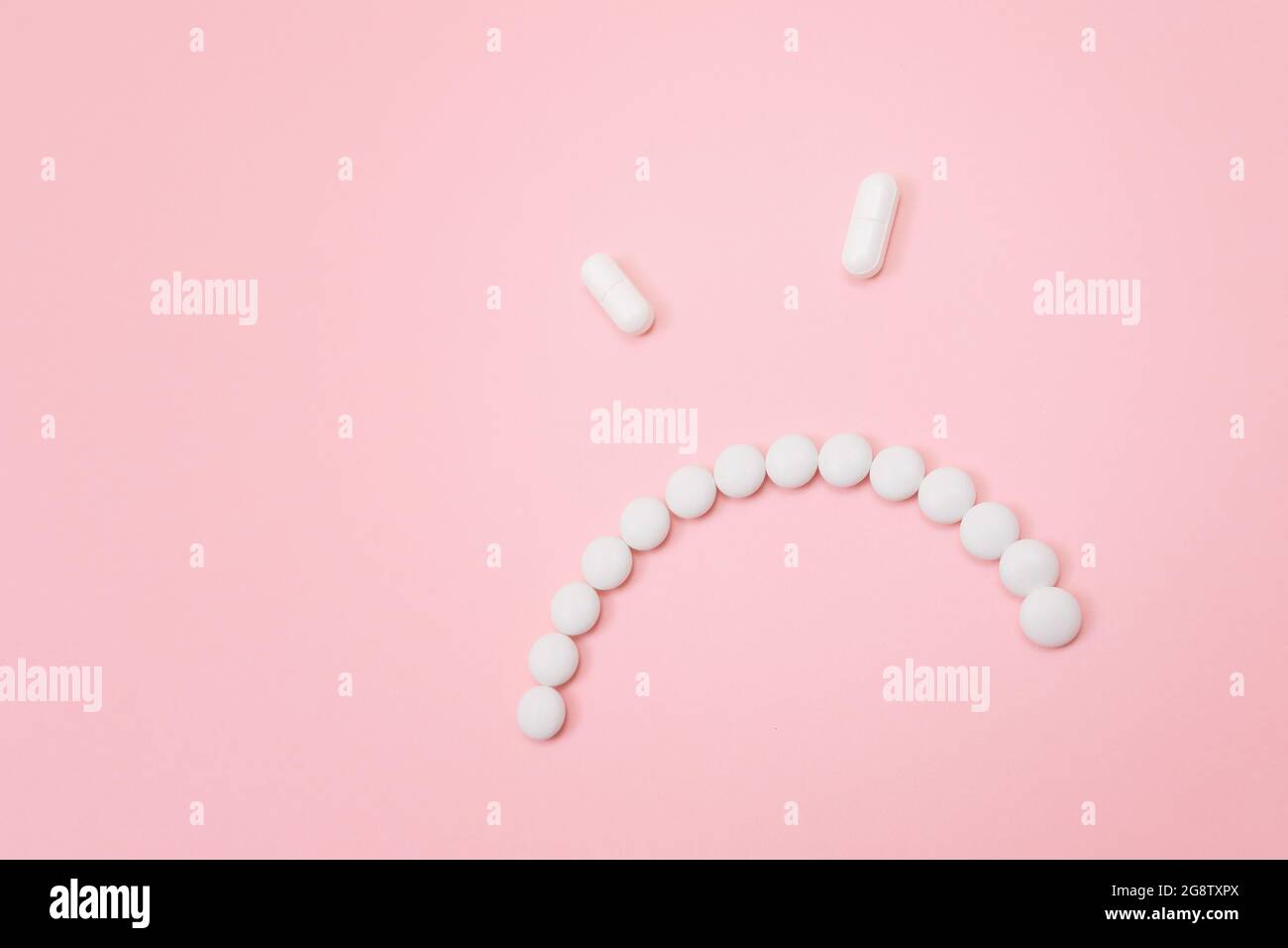 Pharma Harm. Angry Smiley Face Made from White Pills, Lying on Pink ...
