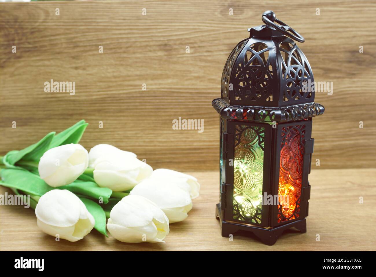 lighting with colorful on muslim lantern shining on wooden background ...