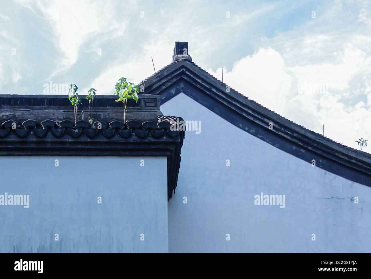 Old traditional chinese building with white mottled wall and small ...