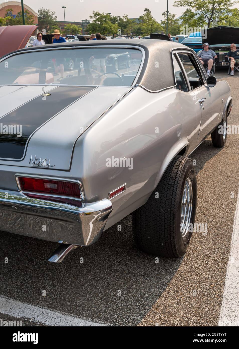 The rear end of a vintage two toned silver with black stripes Chevrolet ...