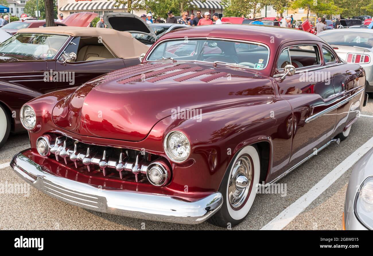A 1951 maroon Mercury Custom coupe on display at a summer vintage car ...