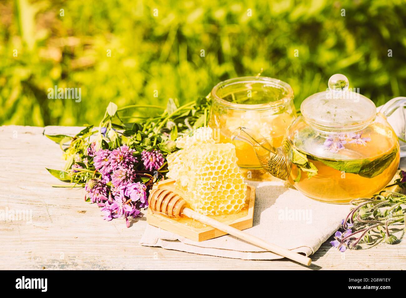 Tea with fresh leaves of summer herbs clover natural liquid honeycomb ...
