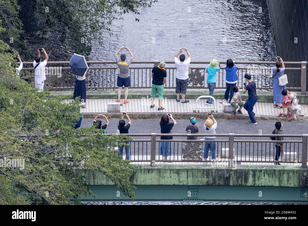 People are seen taking photos of the Japan Air Force Blue Impulse ...