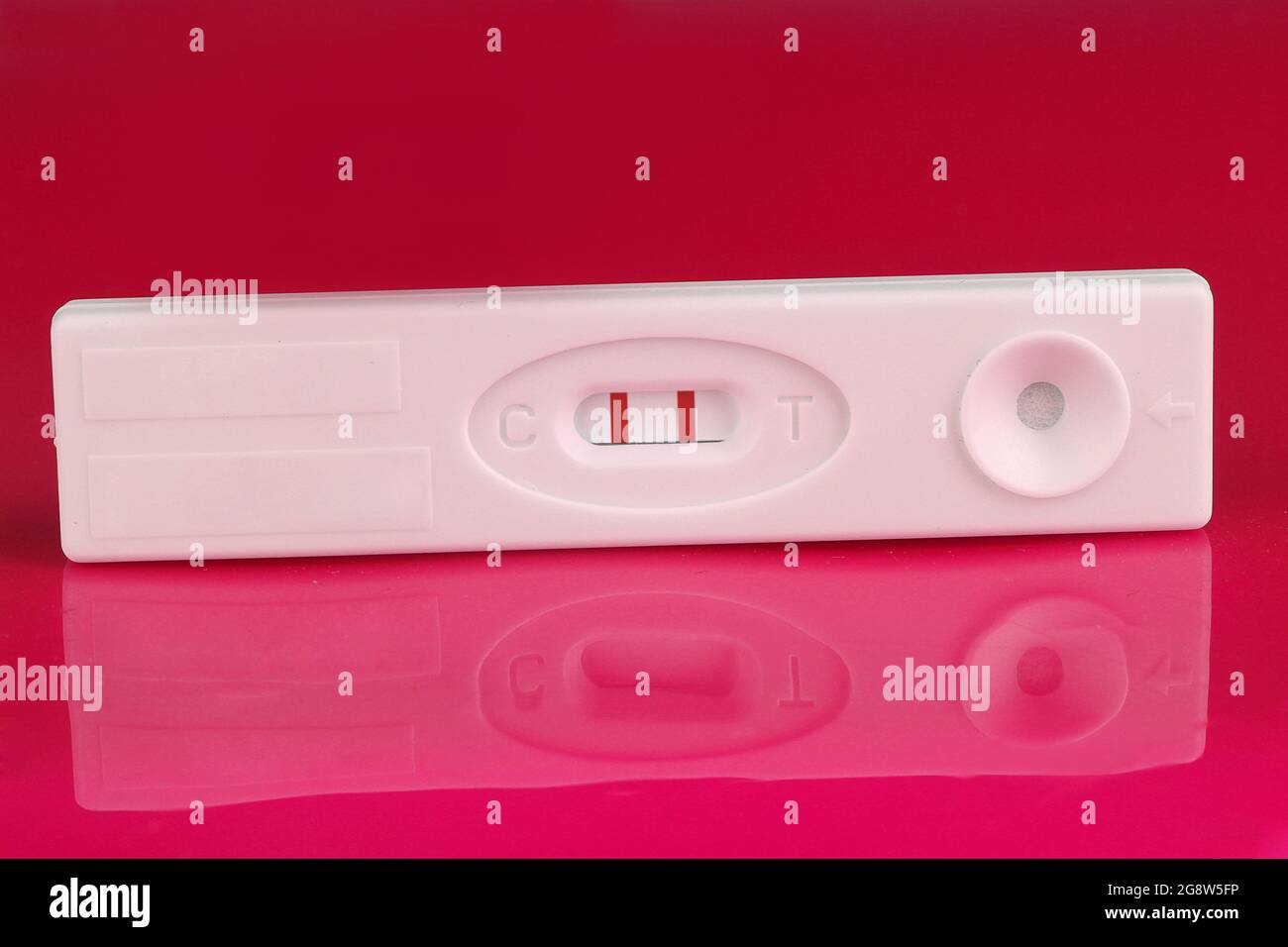 positive pregnancy test on pink background Stock Photo - Alamy