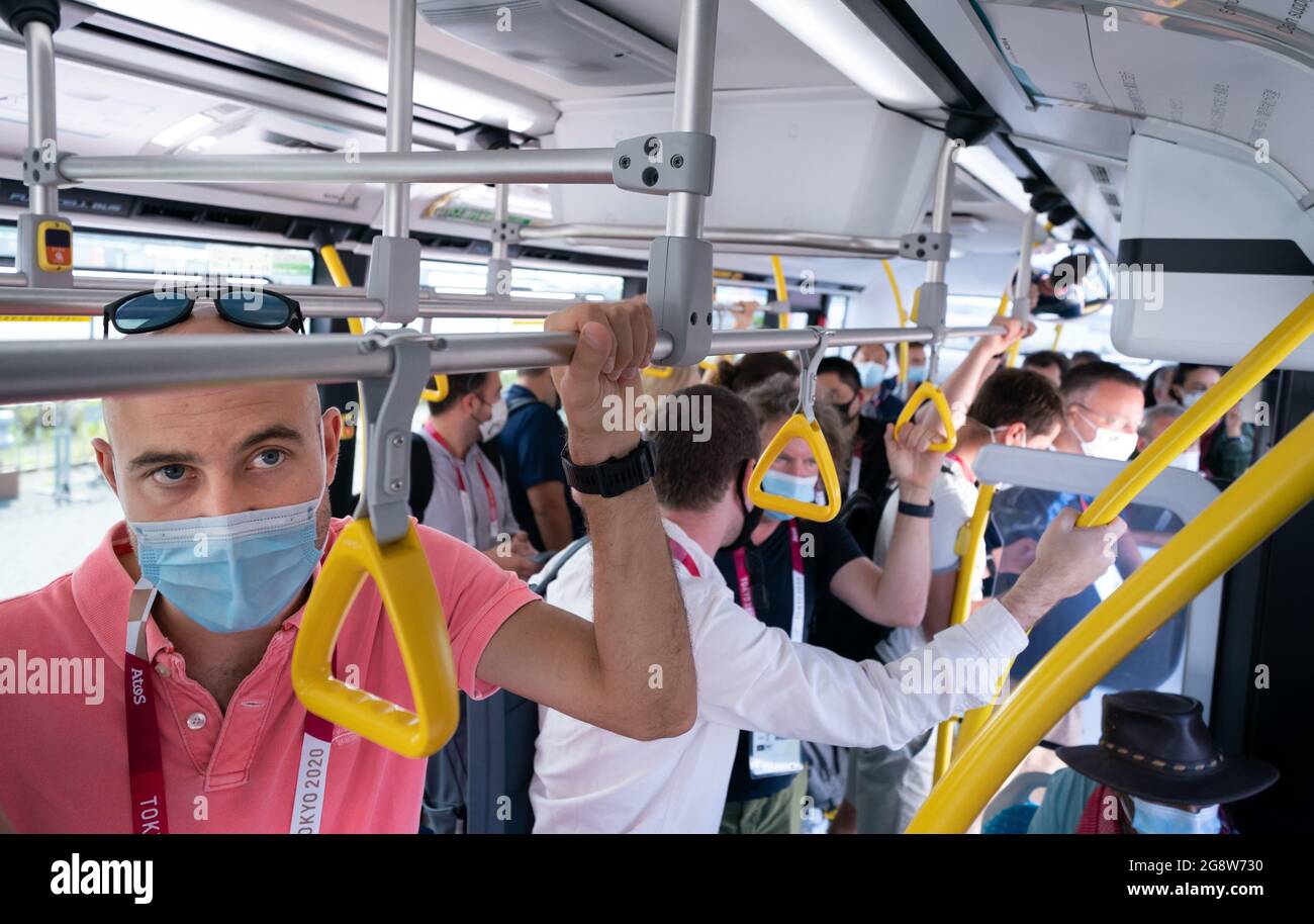 Members of the media on a packed media bus in Tokyo ahead of the Tokyo ...