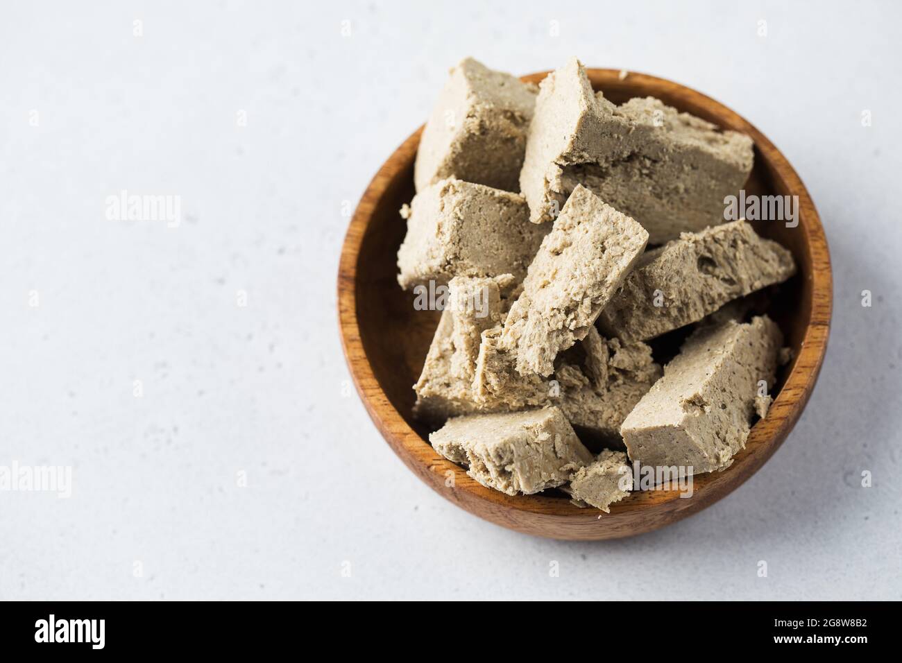 Halva slices in a bowl. Oriental sweetness. Copy space Stock Photo - Alamy