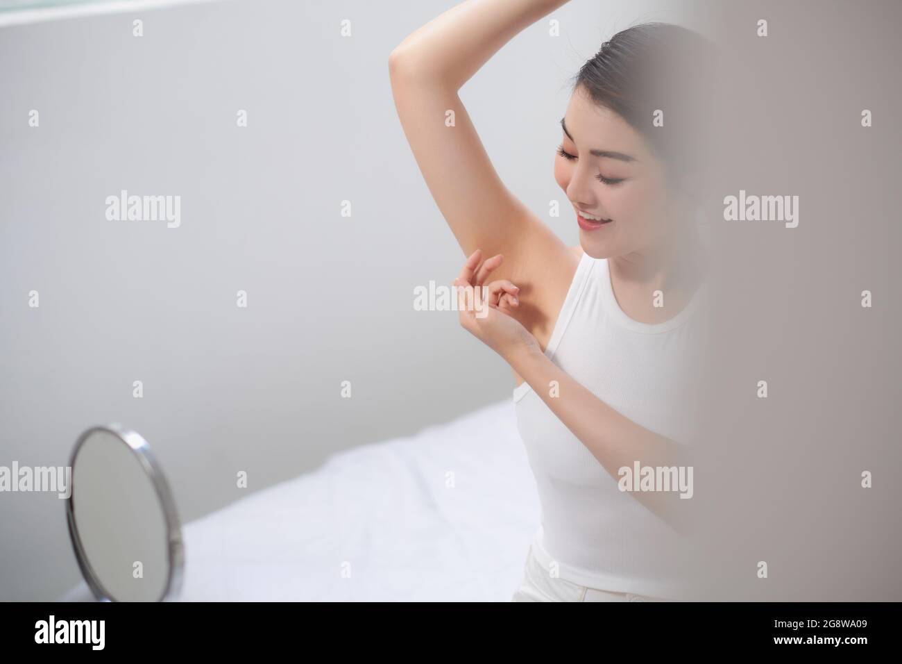 young beautiful woman raises her hands and shows her perfect clean ...