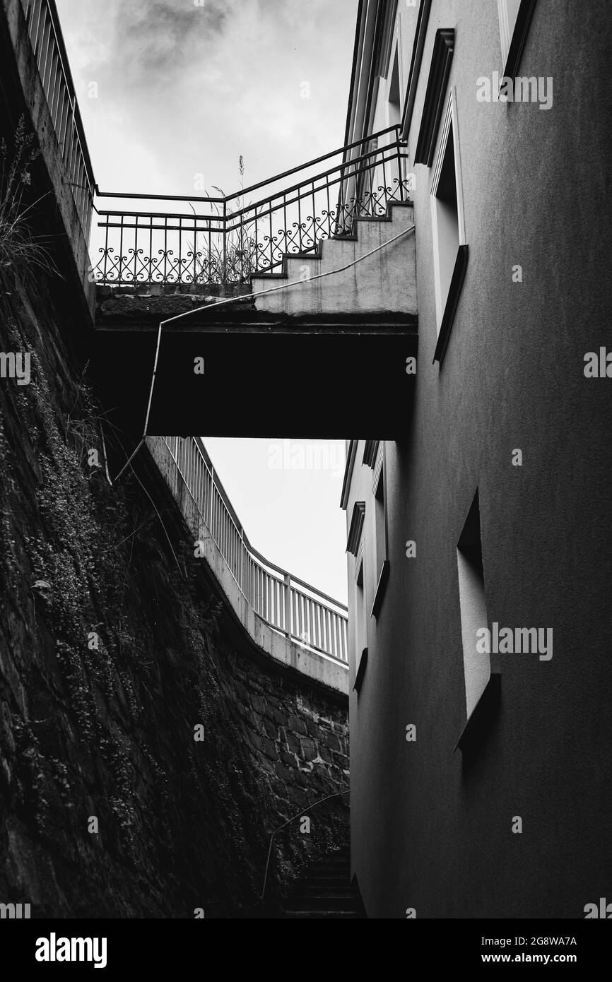 stone stairs between the building, old walls, concrete footbridge to ...
