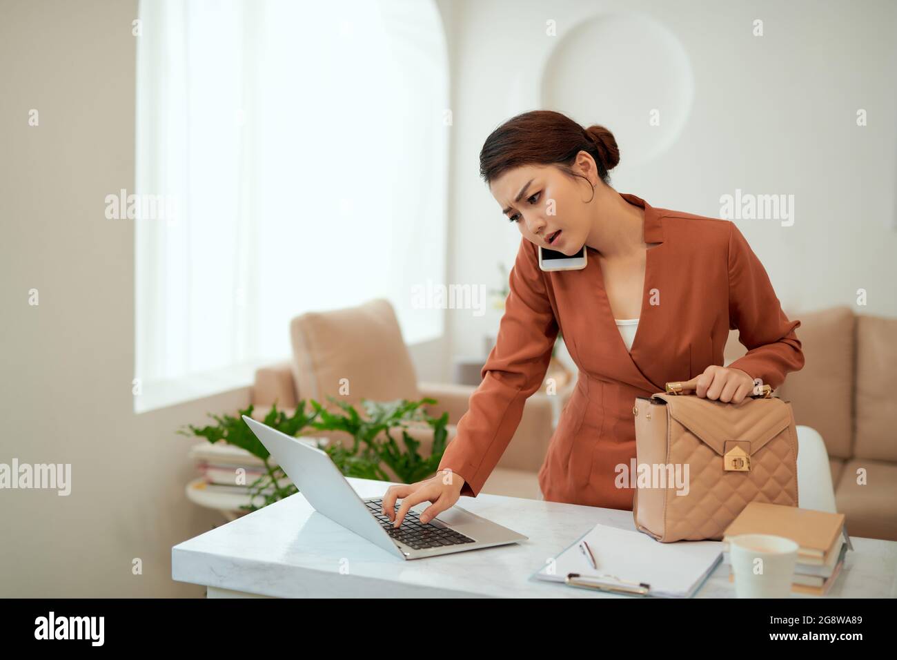 Young woman checking emails in office Stock Photo - Alamy