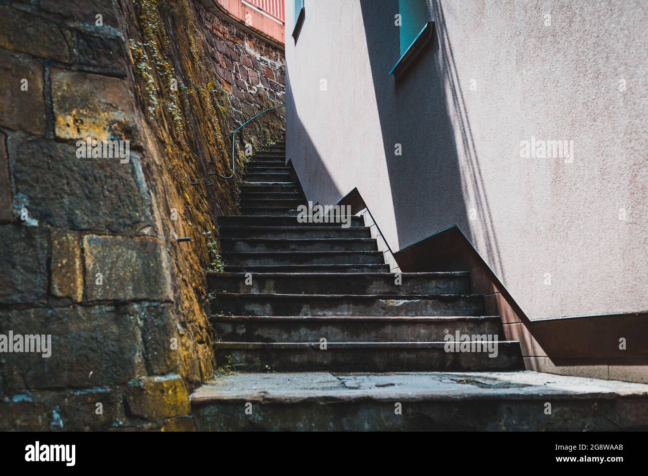 stone stairs between the building and the old wall, old town ...