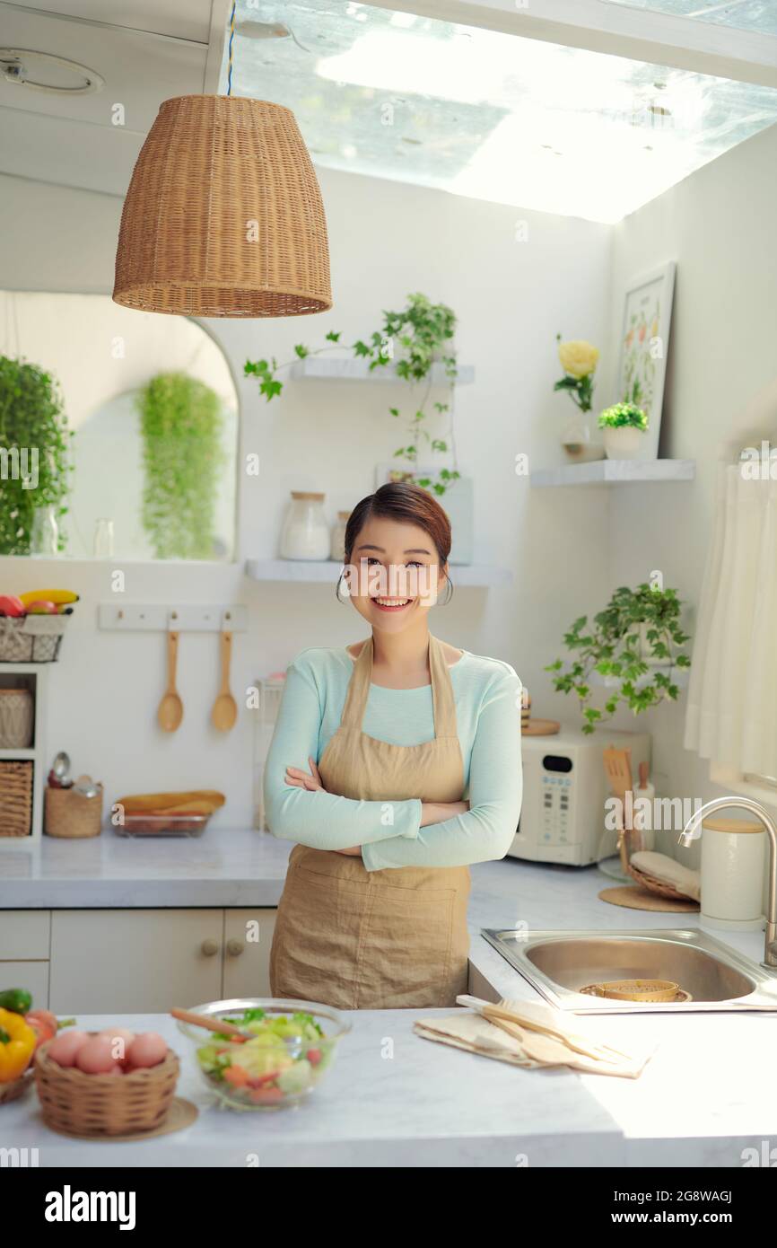 Woman standing her kitchen hi-res stock photography and images - Alamy