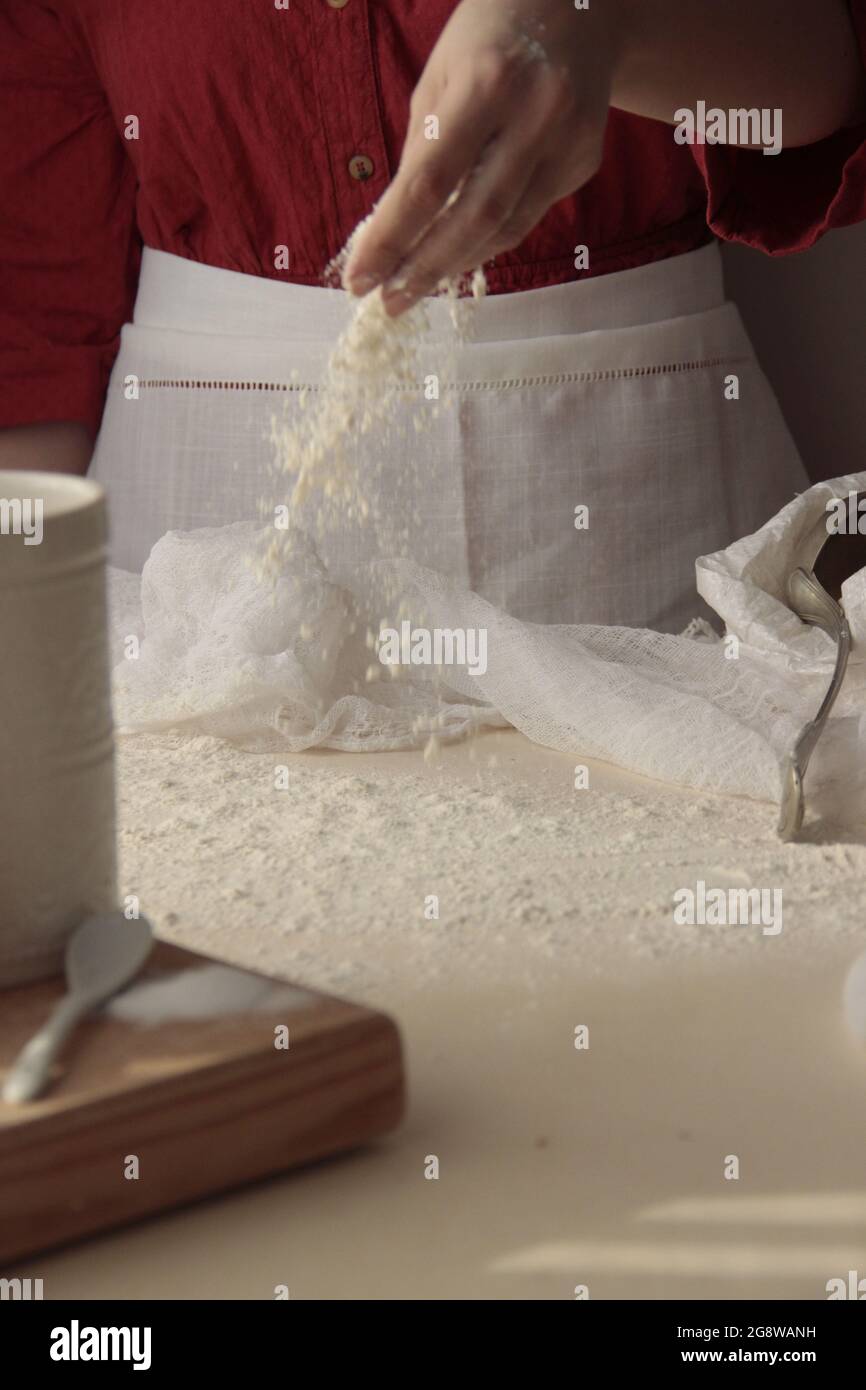 Woman with red dress making bread with flour spreding Stock Photo - Alamy