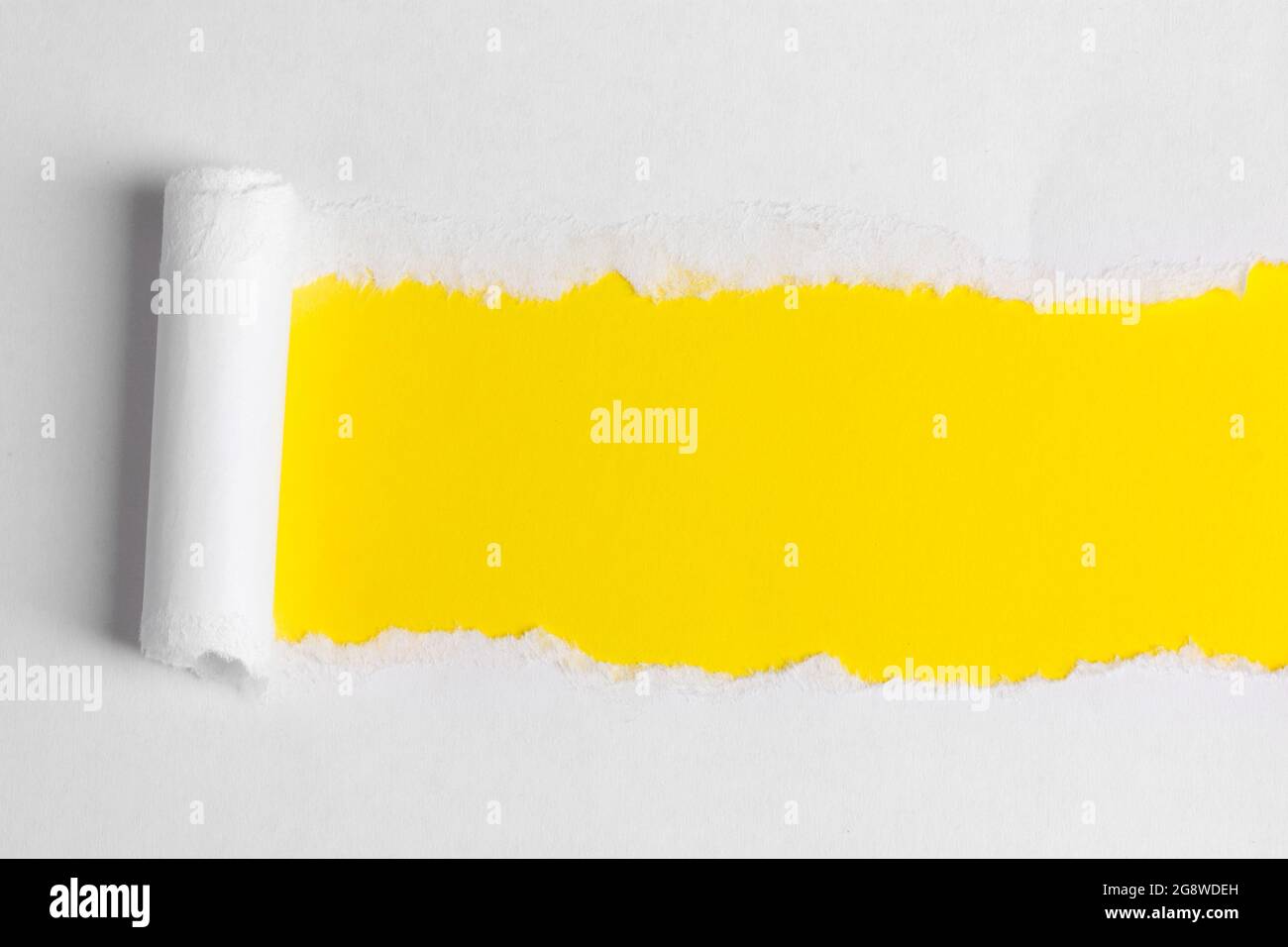 Torn paper with yellow background Stock Photo - Alamy