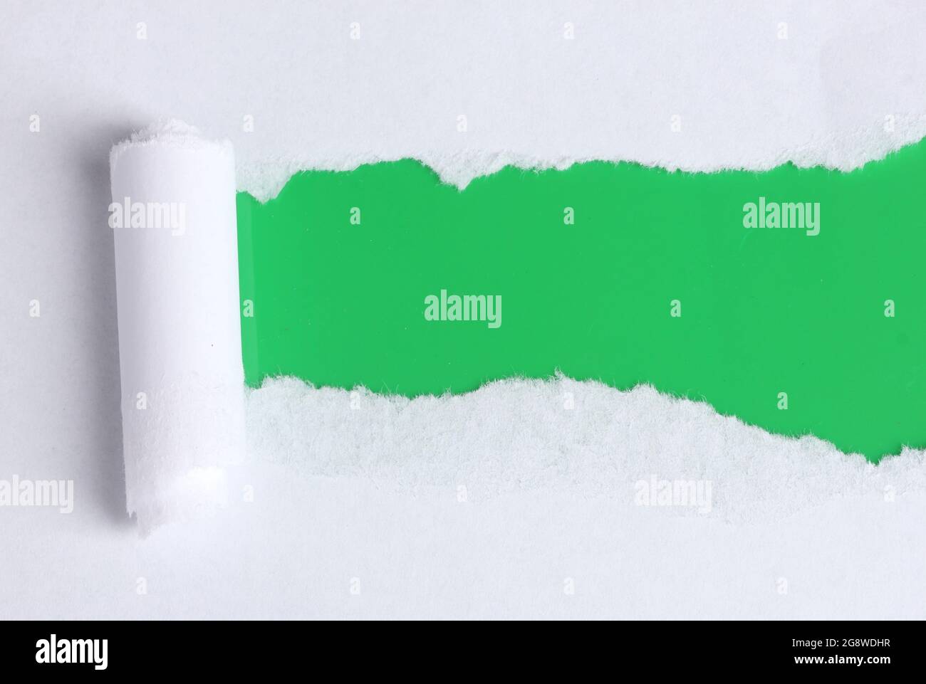 Torn paper with green background Stock Photo - Alamy