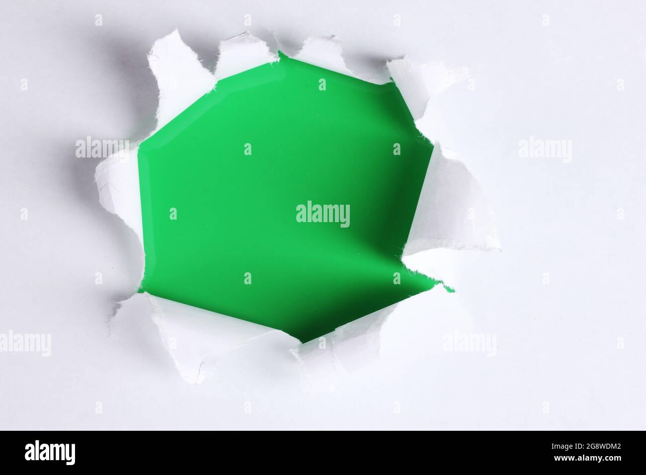 Torn paper with green background Stock Photo - Alamy