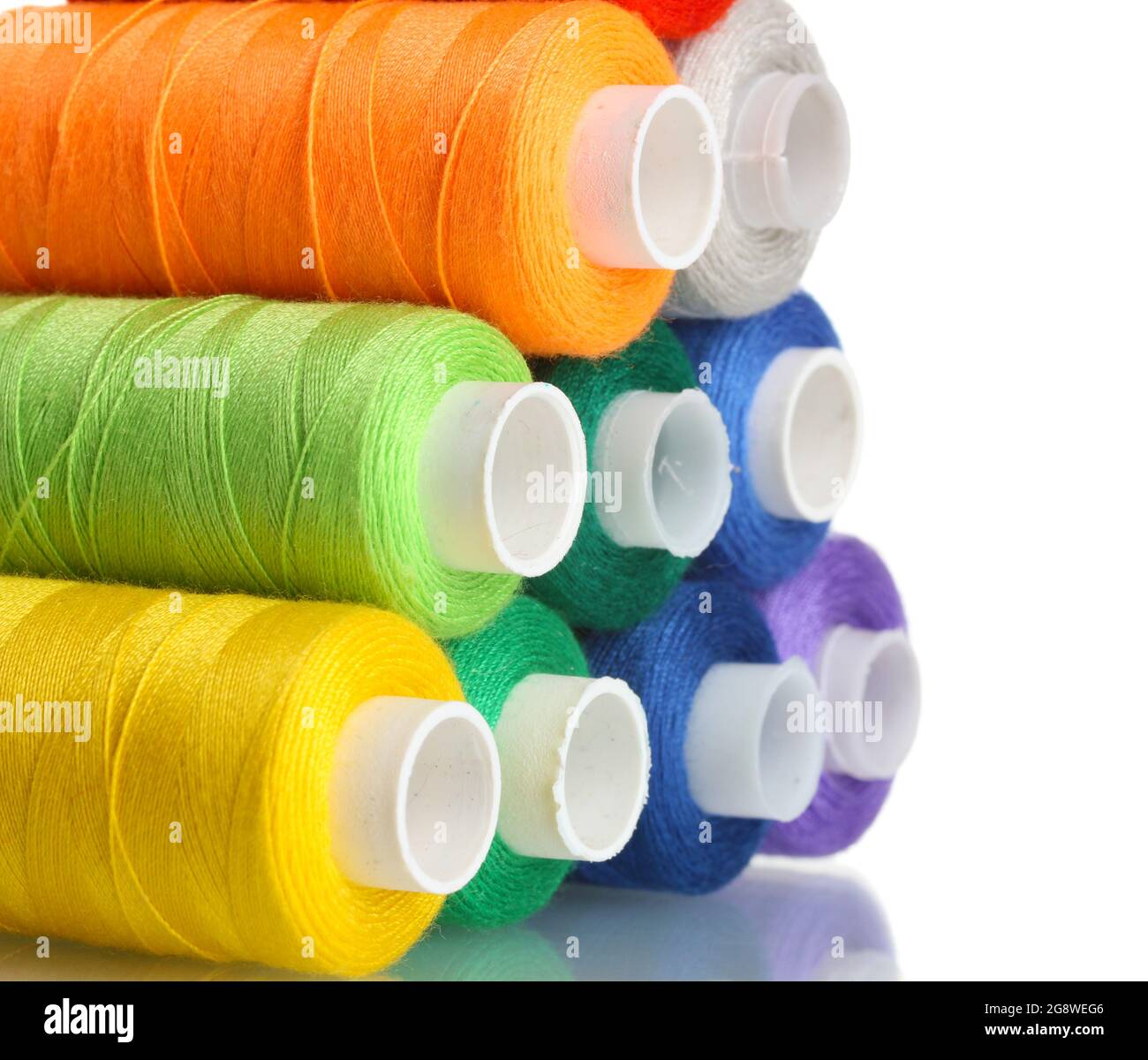 Pyramid of many-coloured bobbins of thread isolated on white Stock ...