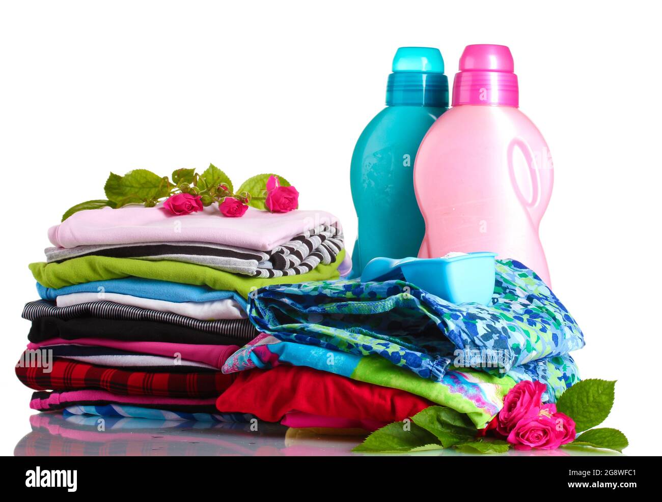 Detergent with washing powder and pile of colorful clothes isolated on ...