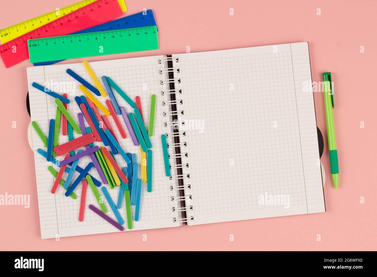 Open school squared notebook, pen, rulers, colorful math sticks on the ...