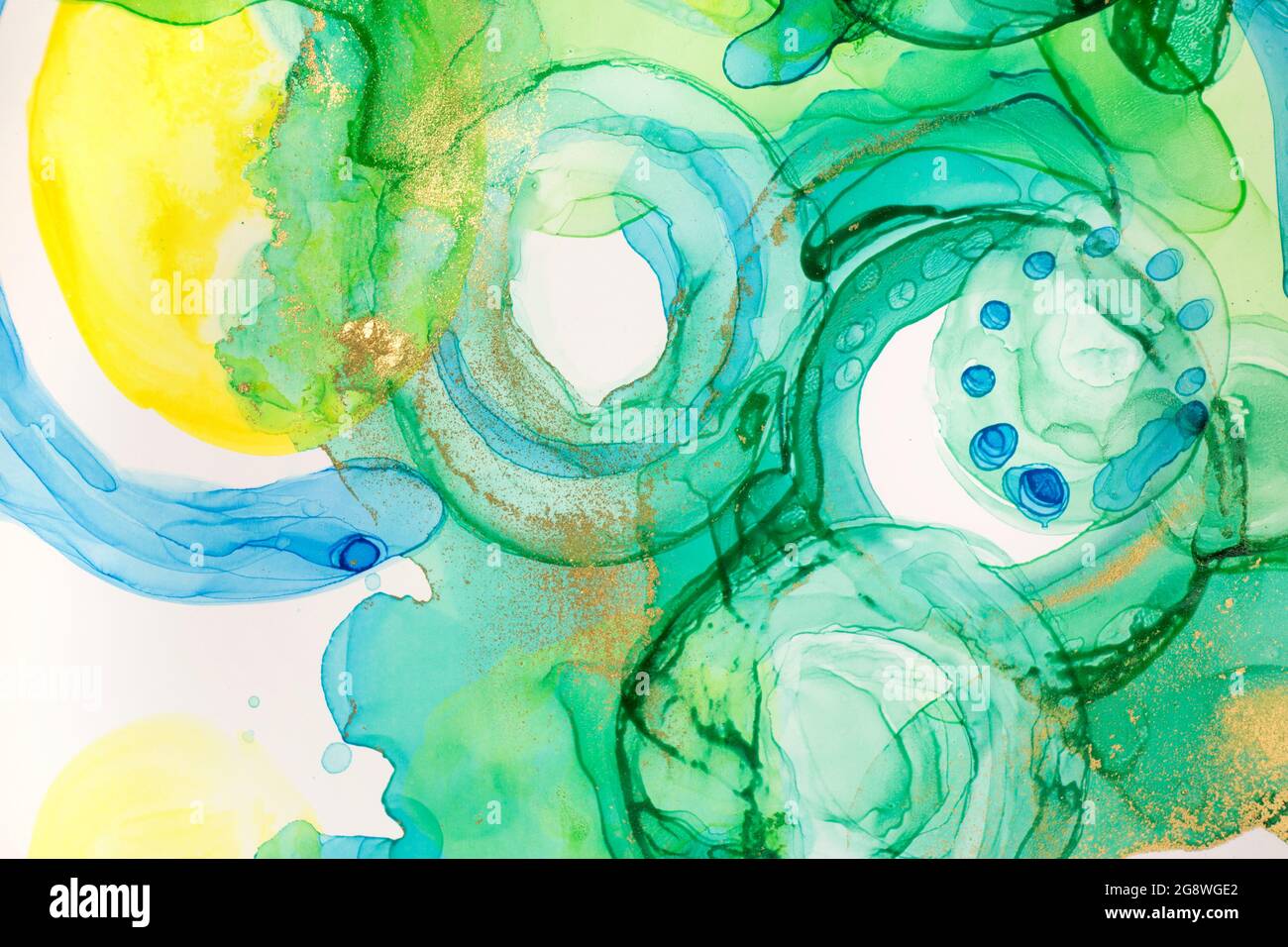 Abstract ink blue, green and yellow watercolor ink drops background ...