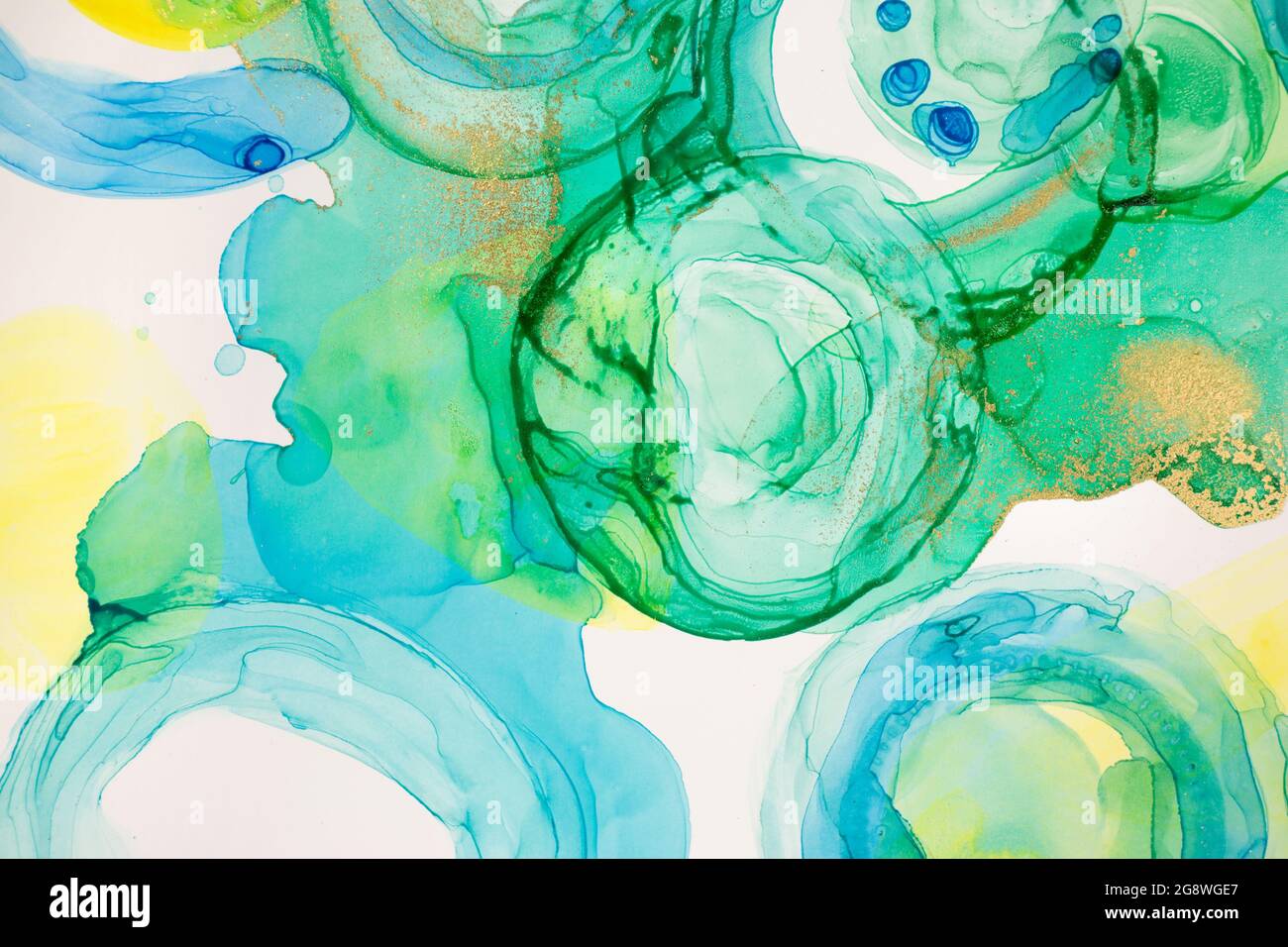 Abstract ink blue, green and yellow watercolor ink drops background ...