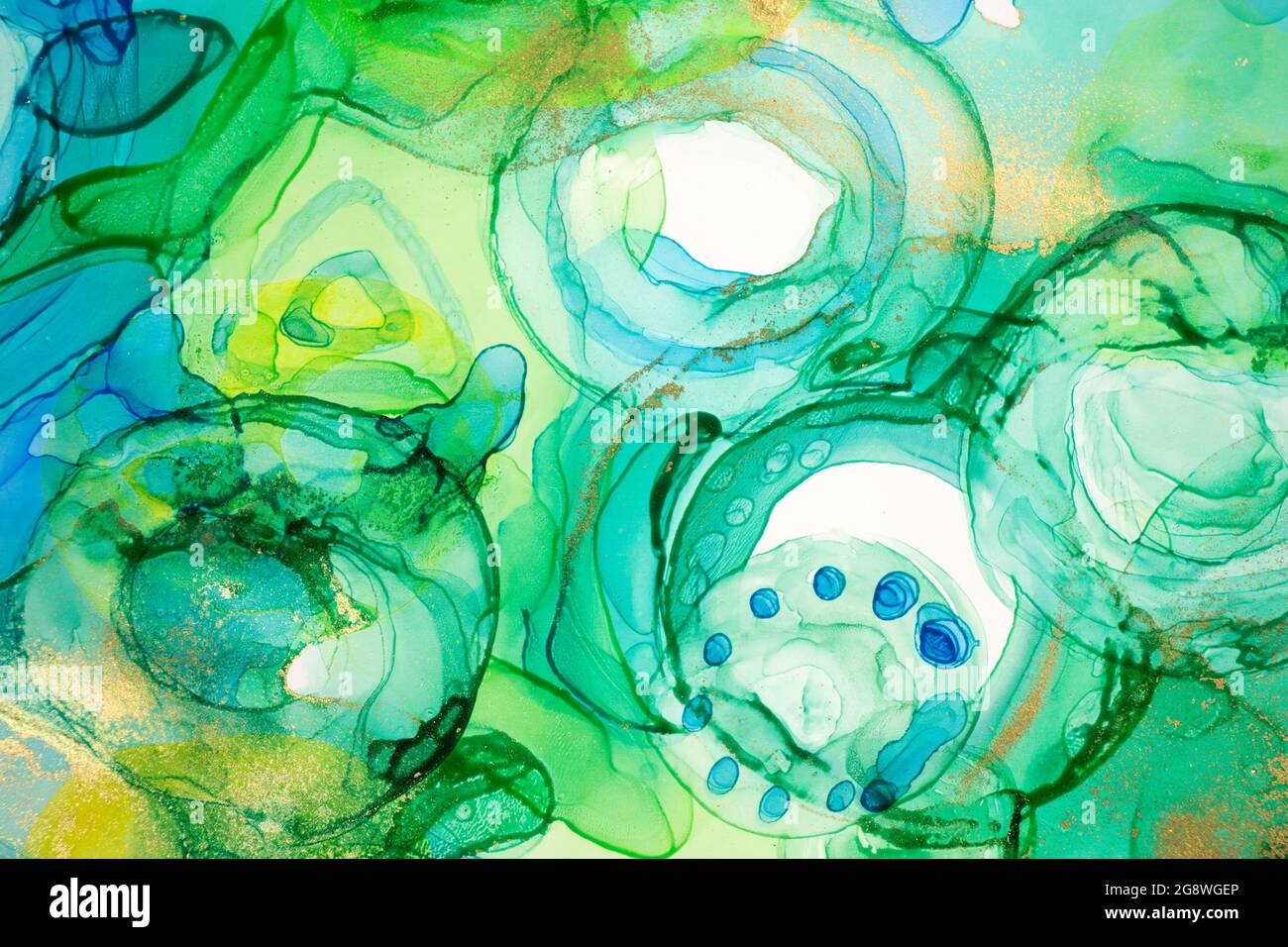 Abstract ink blue, green and yellow watercolor ink drops background ...