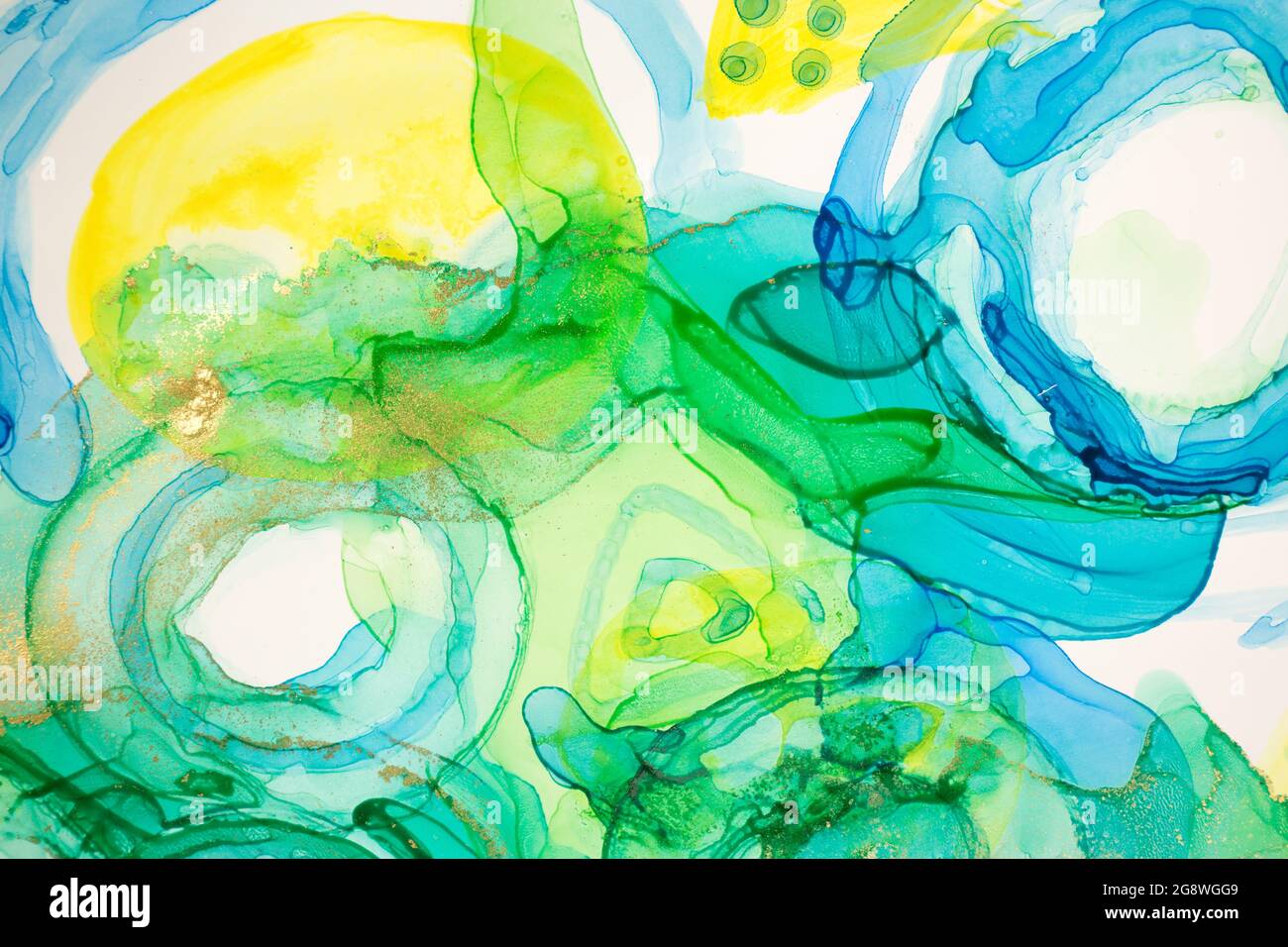 Abstract ink blue, green and yellow watercolor ink drops background ...