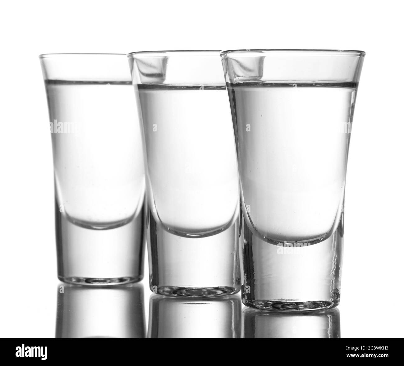 Three glass of vodka isolated on white Stock Photo - Alamy