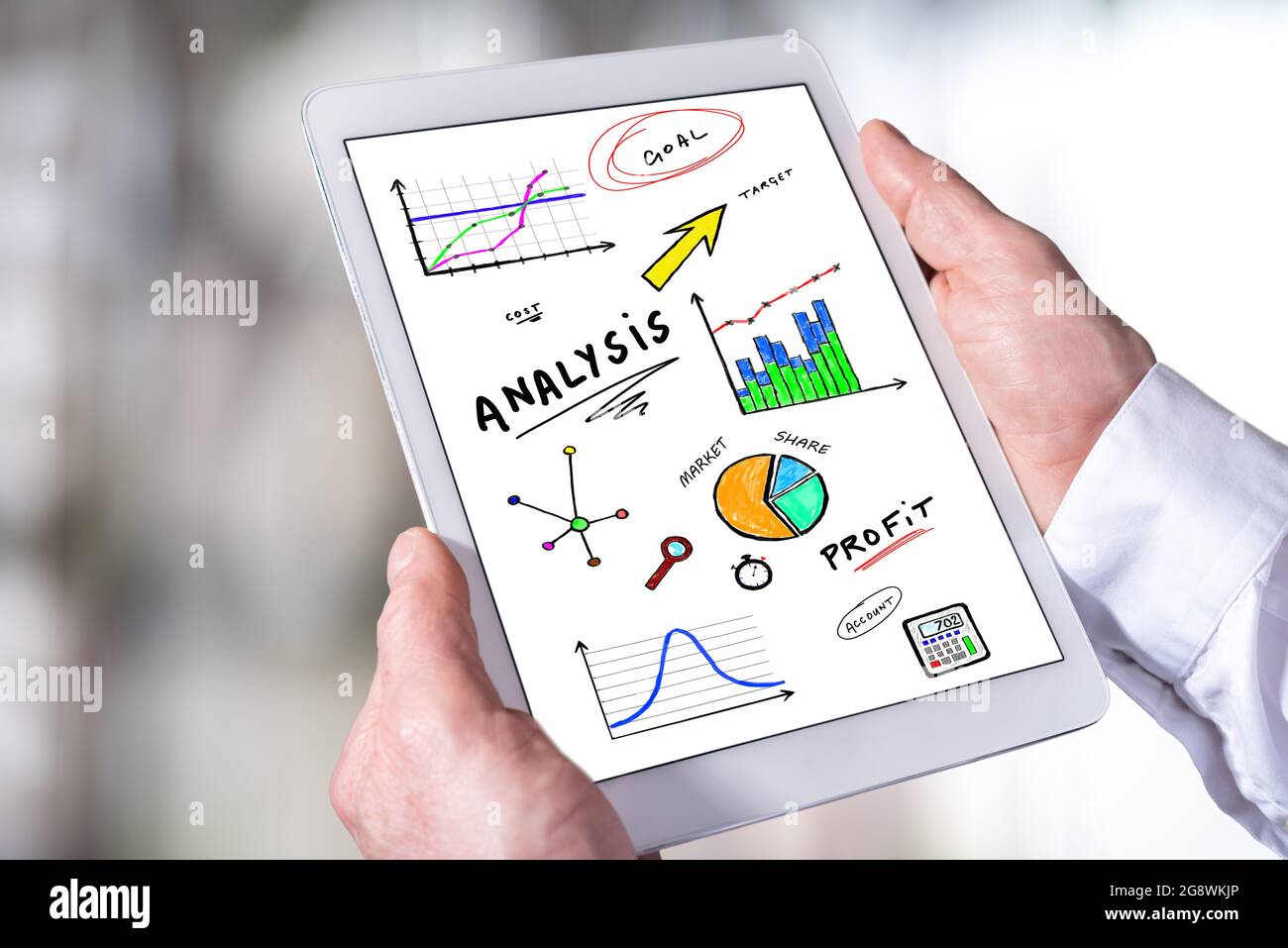 Man holding a tablet showing analysis concept Stock Photo - Alamy