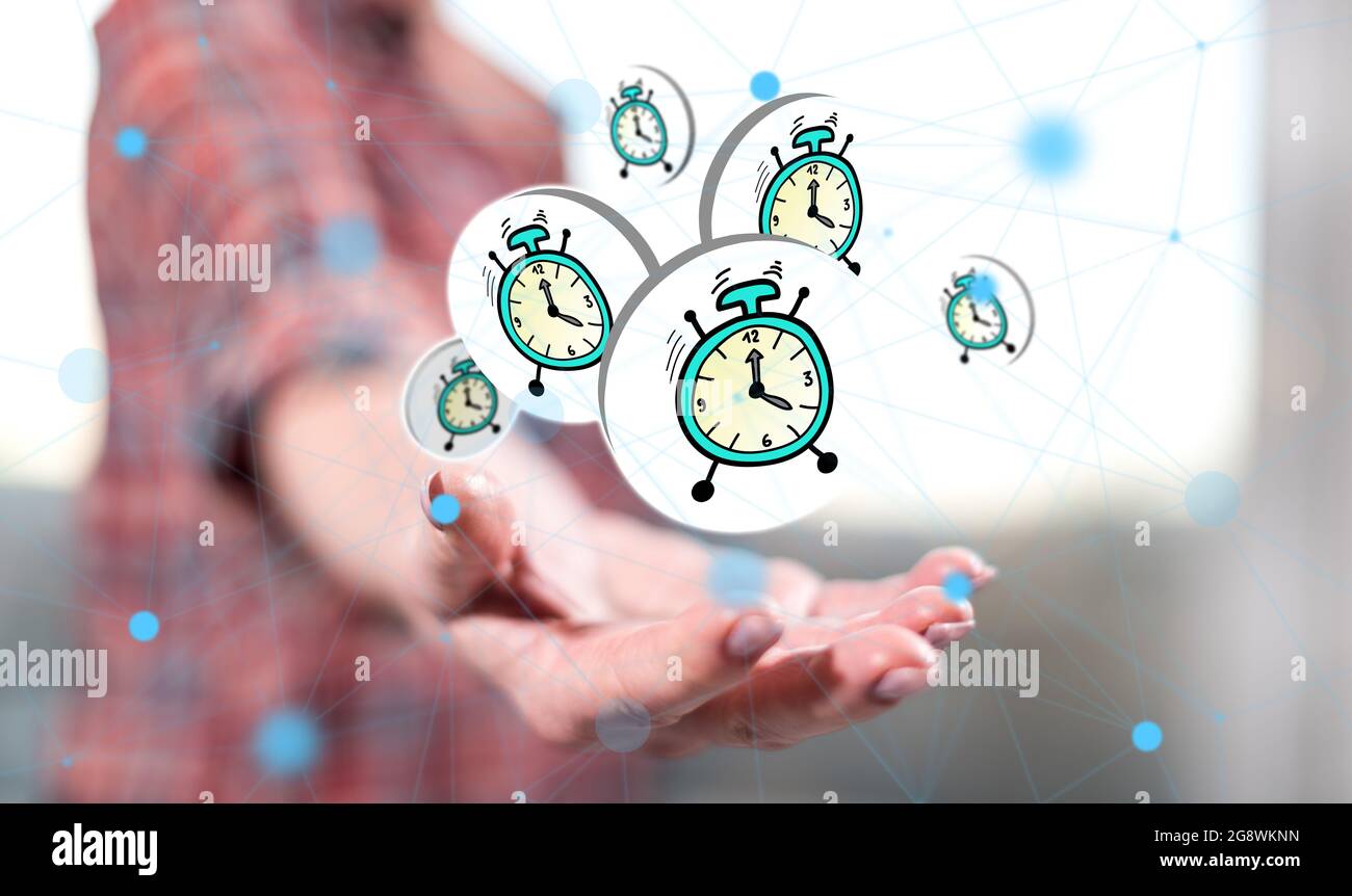 Time concept above the hand of a woman in background Stock Photo - Alamy