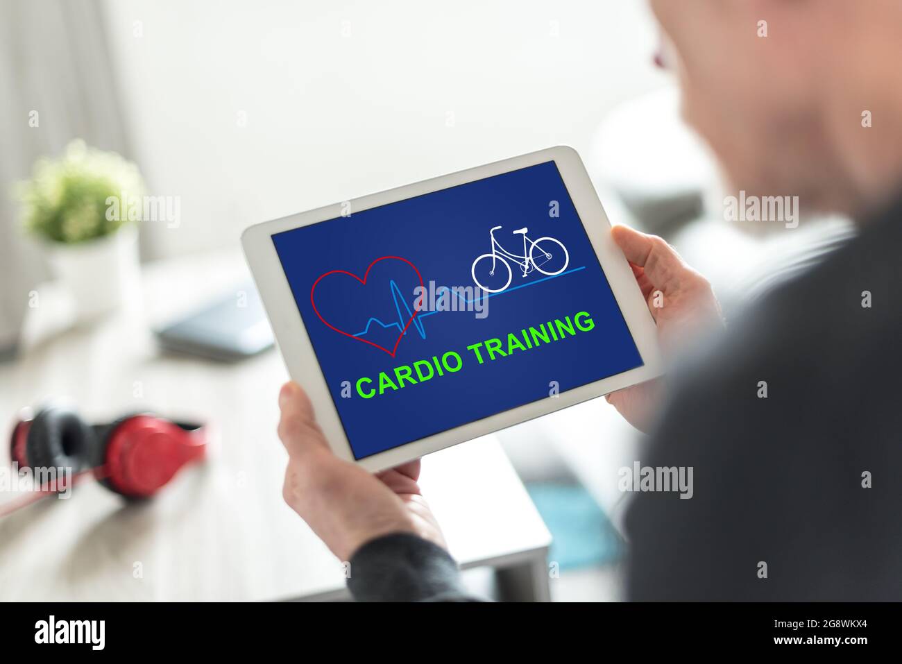 Tablet screen displaying a cardio training concept Stock Photo - Alamy