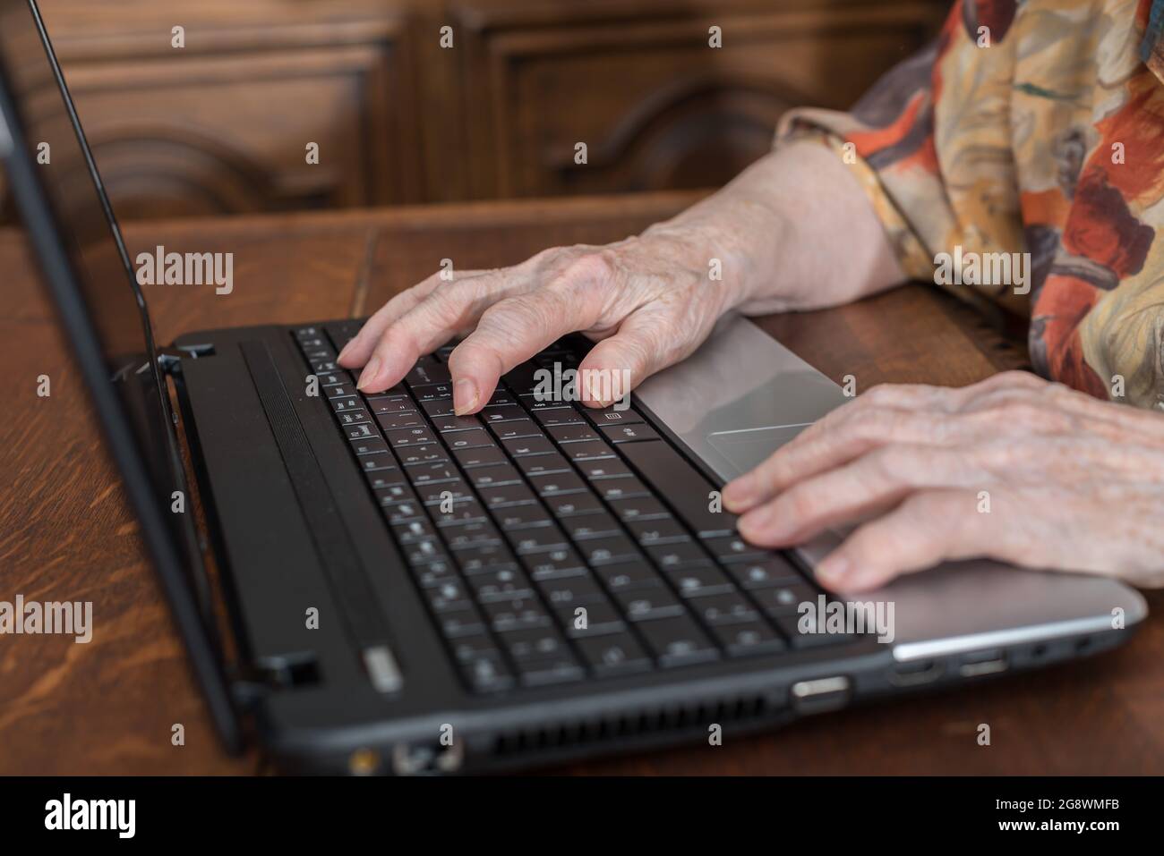 Old woman hands typing on a laptop keyboard Stock Photo - Alamy