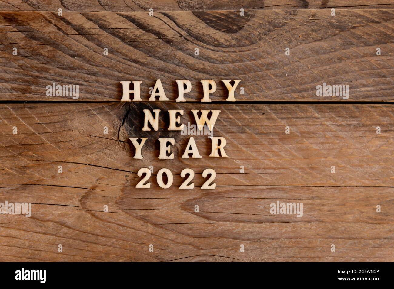 Happy New Year 2022. Quote made from wooden letters and numbers 2022 on ...