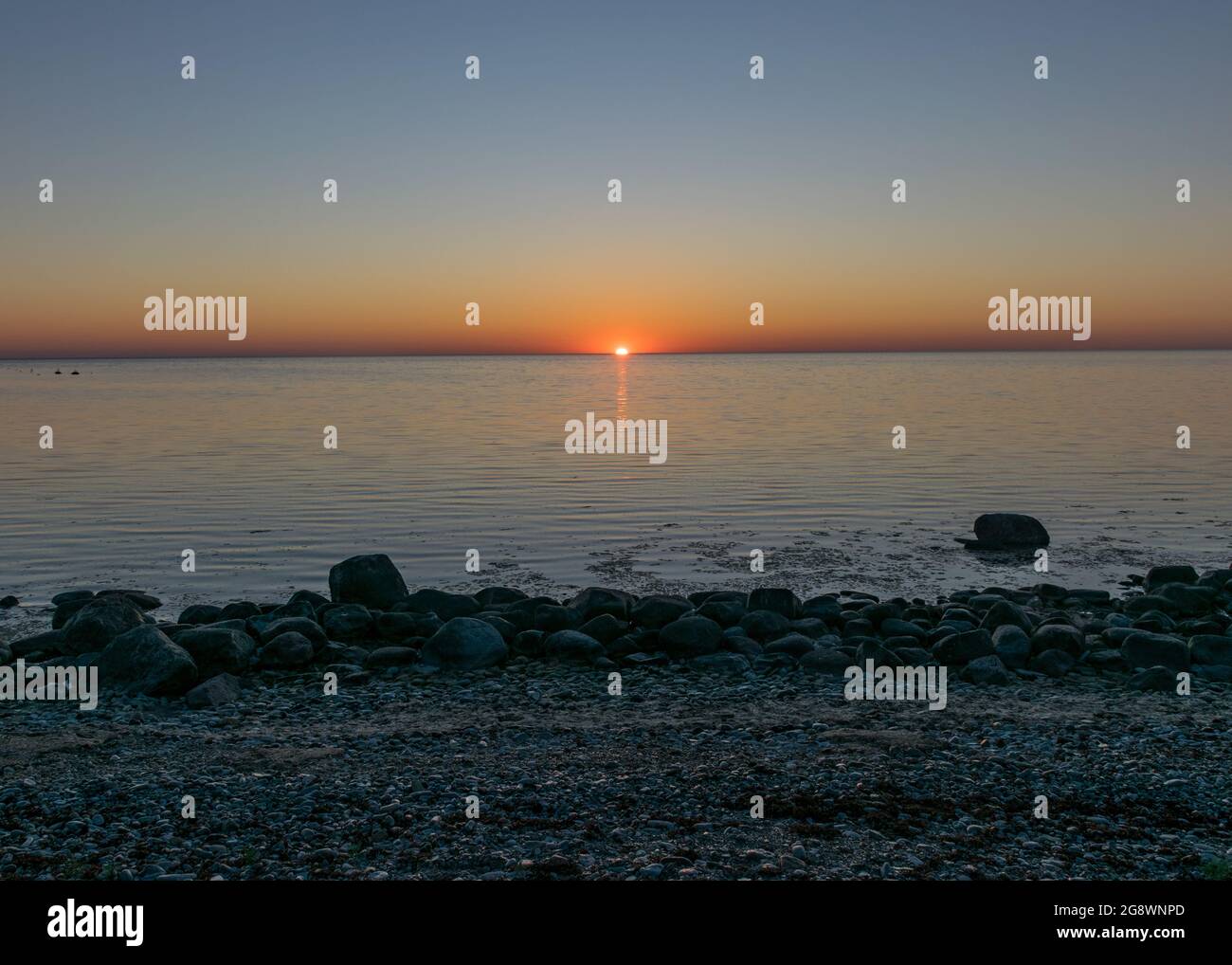 beautiful sunset landscape from a traditional rocky beach on the island ...