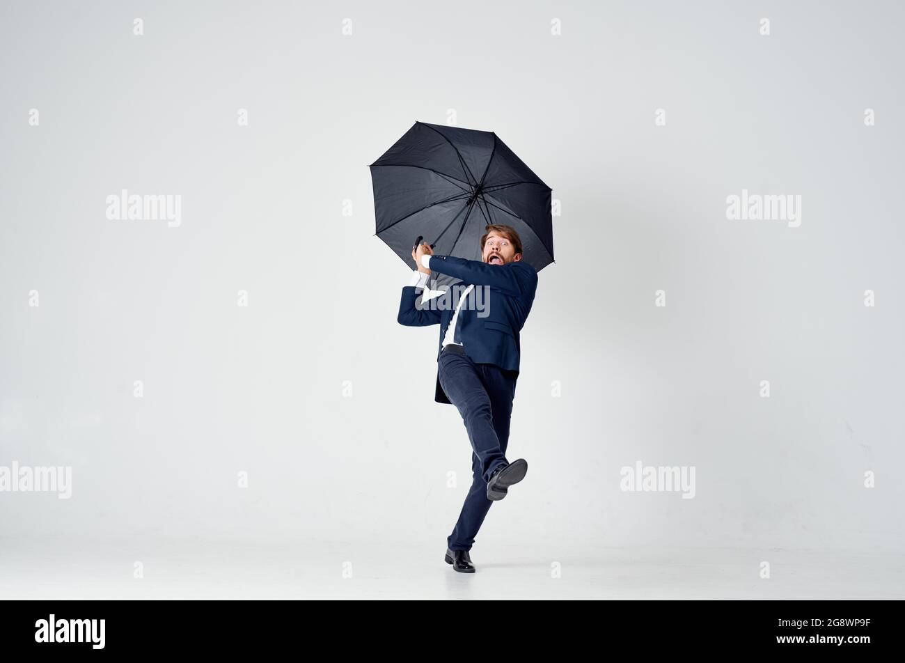 man in suit with umbrella weather protection from rain Stock Photo - Alamy