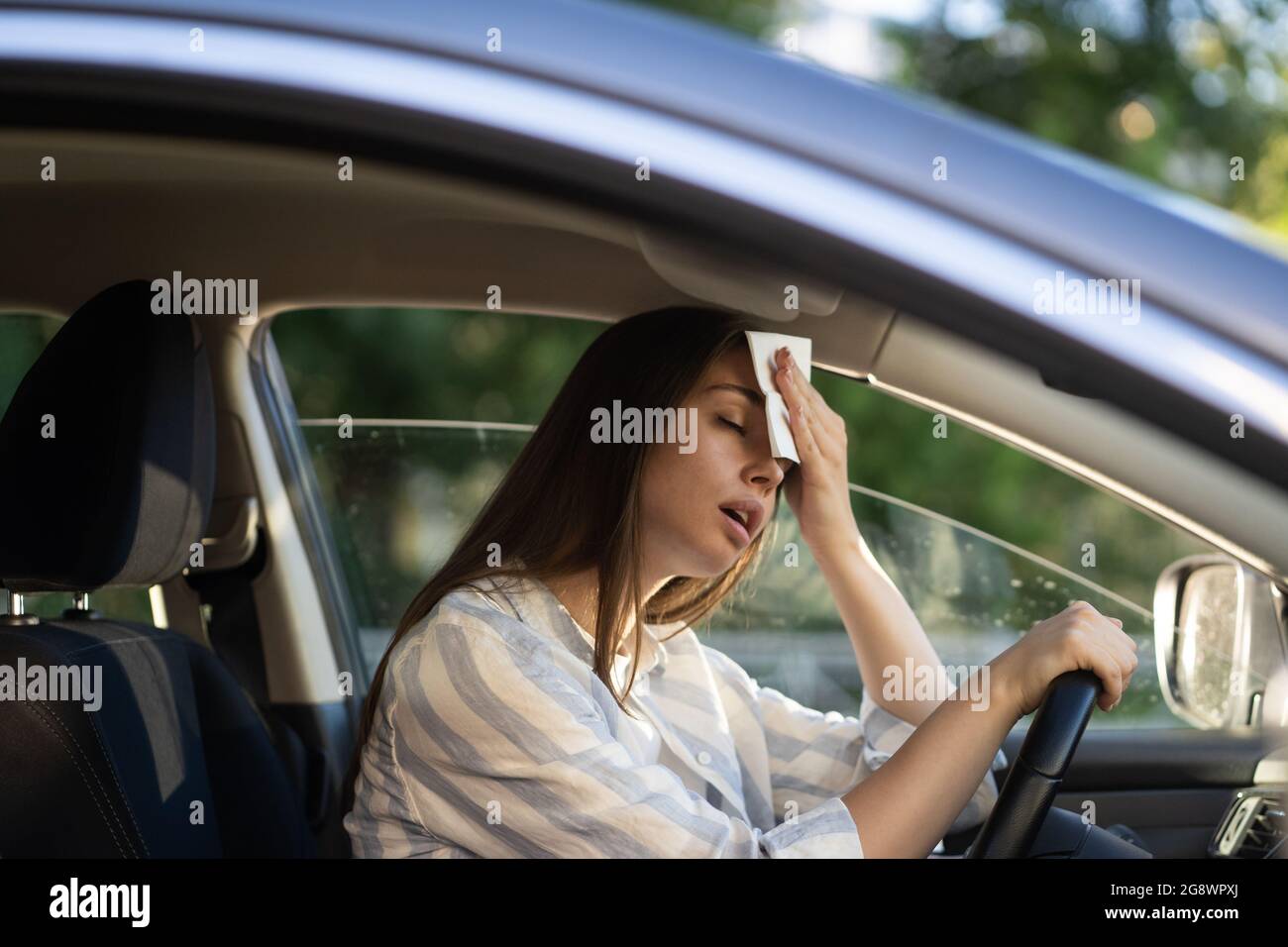 Woman driver being hot during heat wave in car, suffering from hot ...
