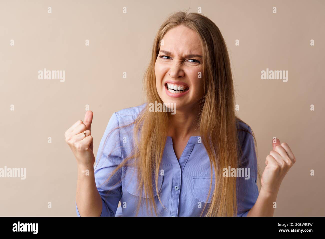 Angry stressed mad young woman against beige background Stock Photo - Alamy